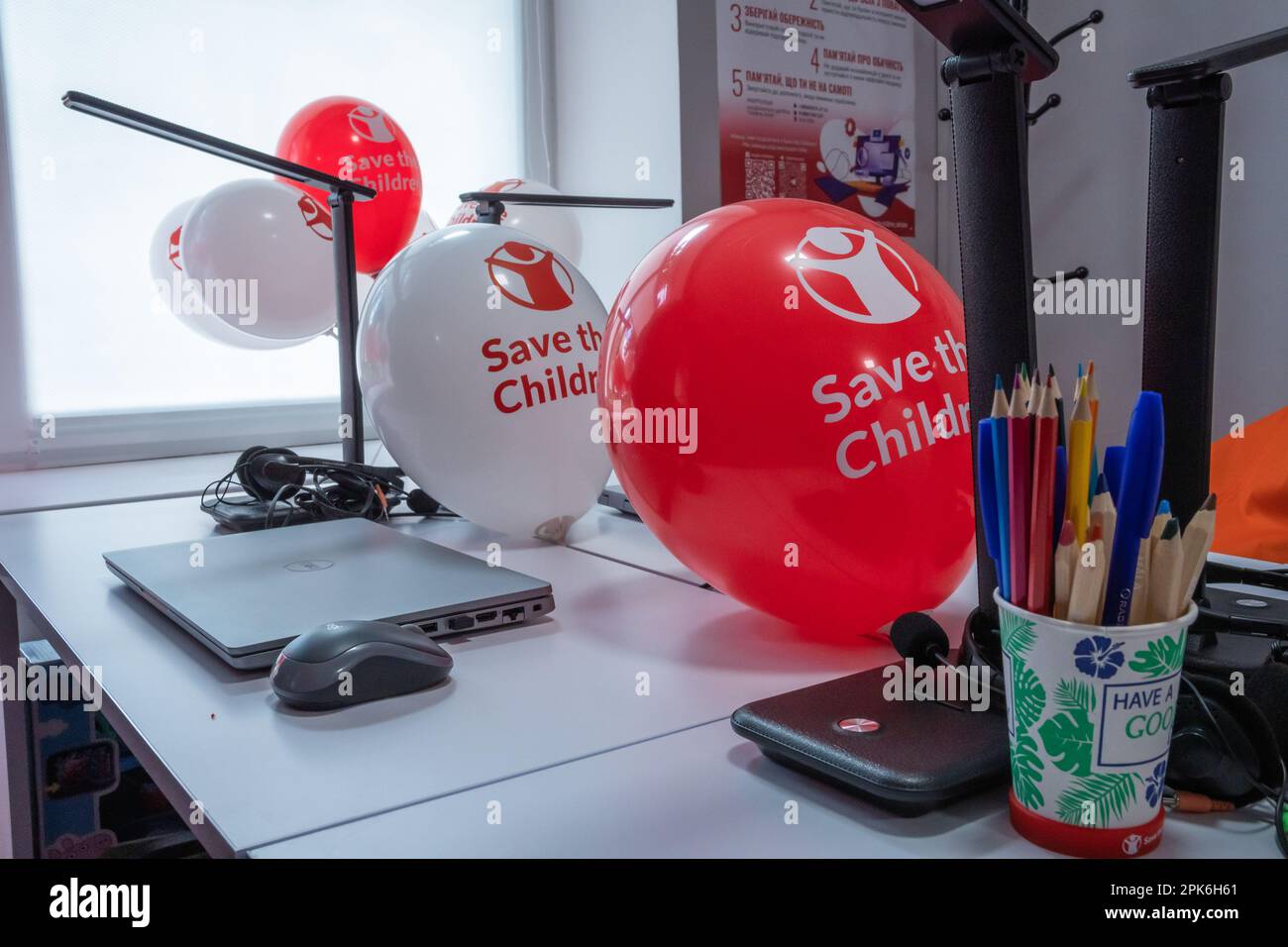 A table with laptops and office supplies in a learning center. Official ...
