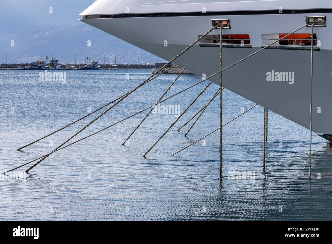 Bow of anchored white yacht with many anchor lines, Rijeka, Croatia ...