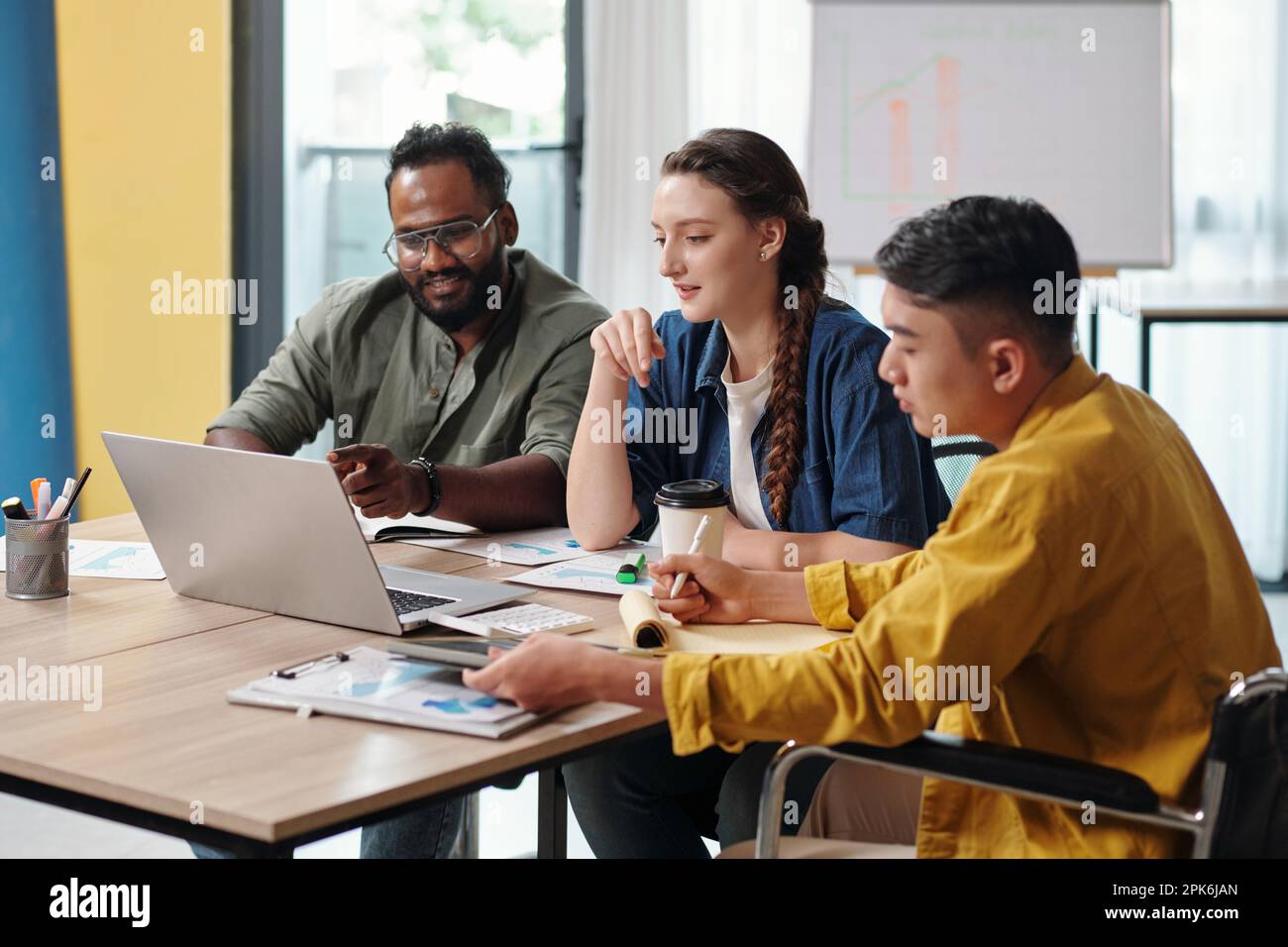 Positive diverse business team discussing trends at meeting Stock Photo ...