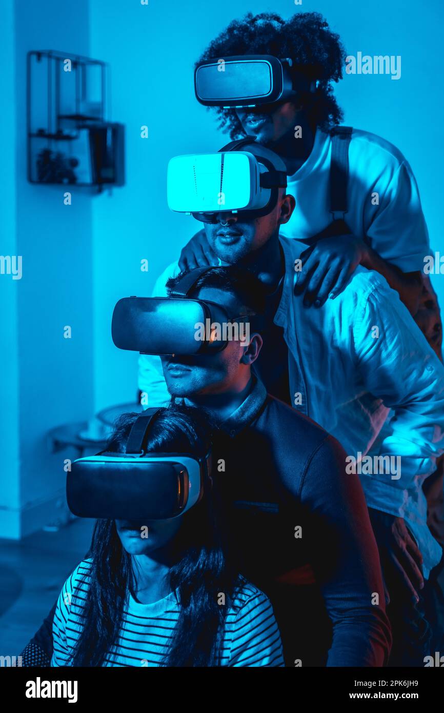 Group of young people with vr glasses in a virtual reality game in a ...