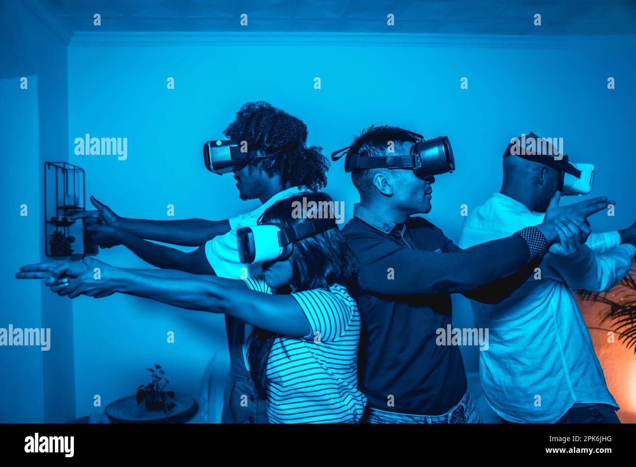 Group of young people with vr glasses in a virtual reality game in a ...