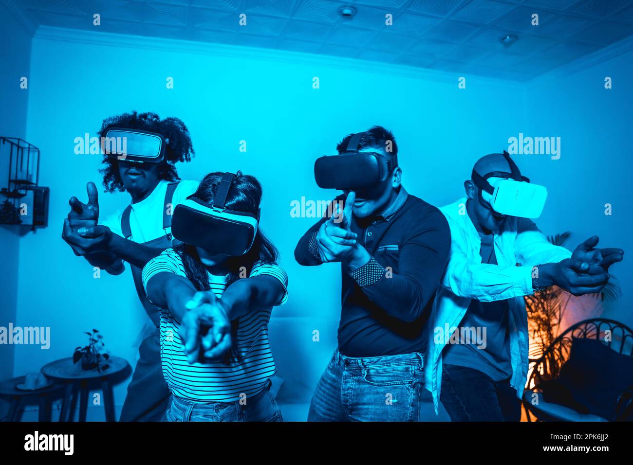 Group of young people with vr glasses in a virtual reality game in a ...