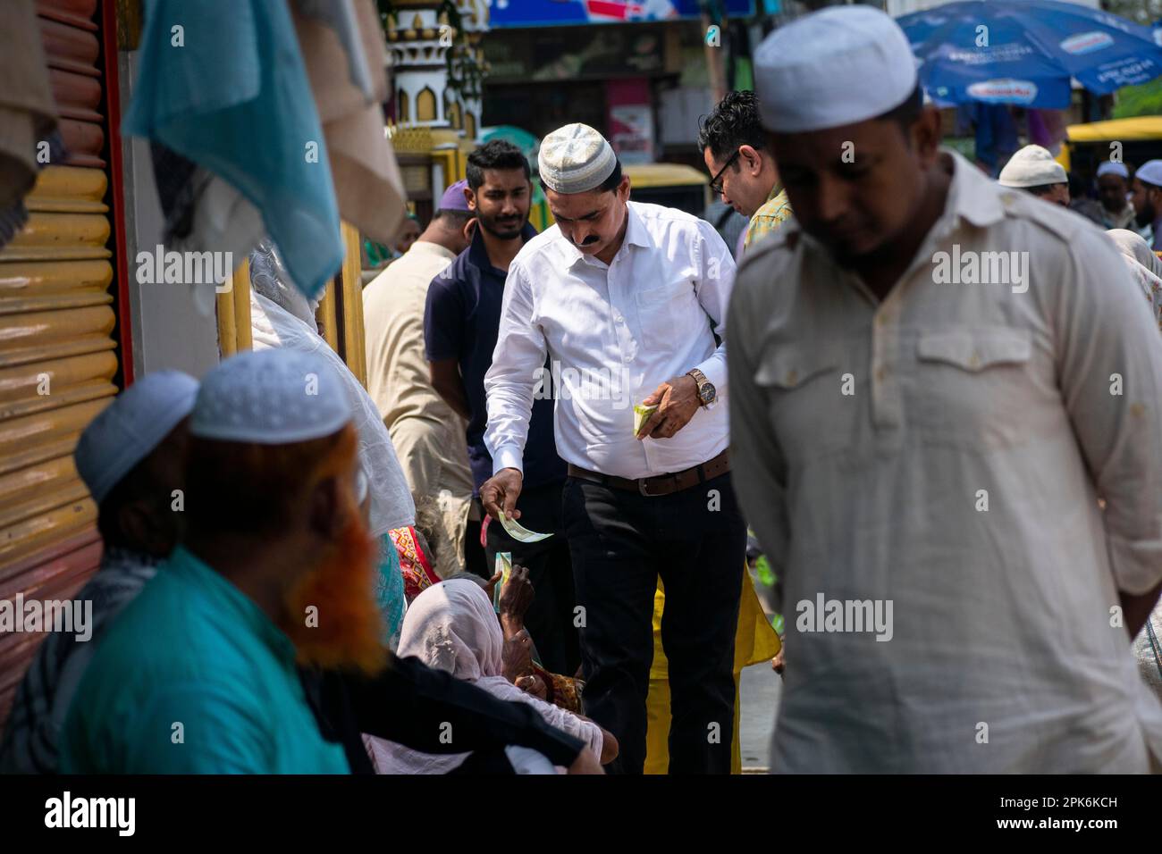 Indian Muslims person give money to needy people after perform the ...