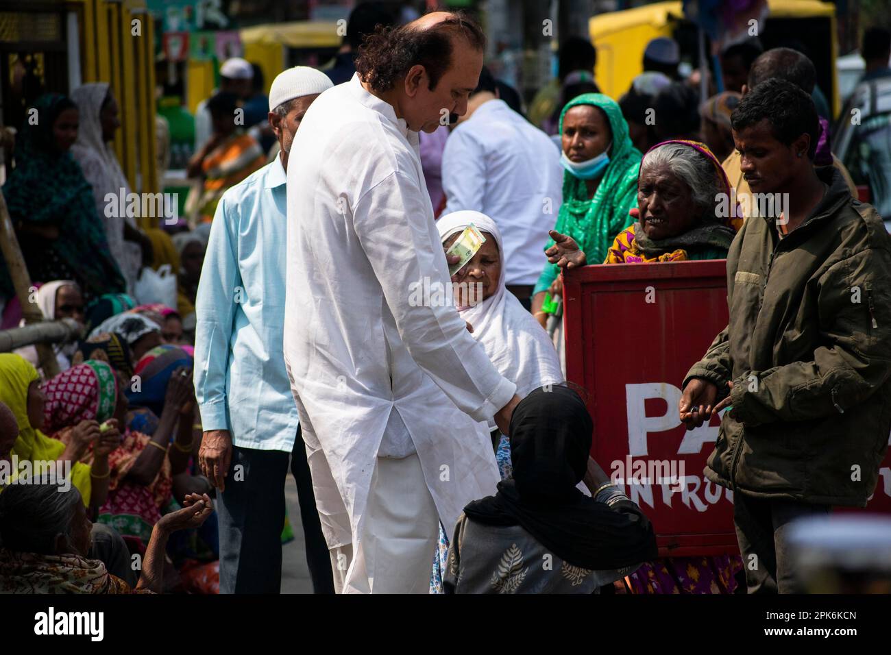 Indian Muslims person give money to needy people after perform the ...