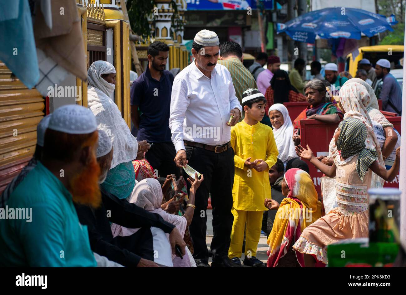 Indian Muslims person give money to needy people after perform the ...