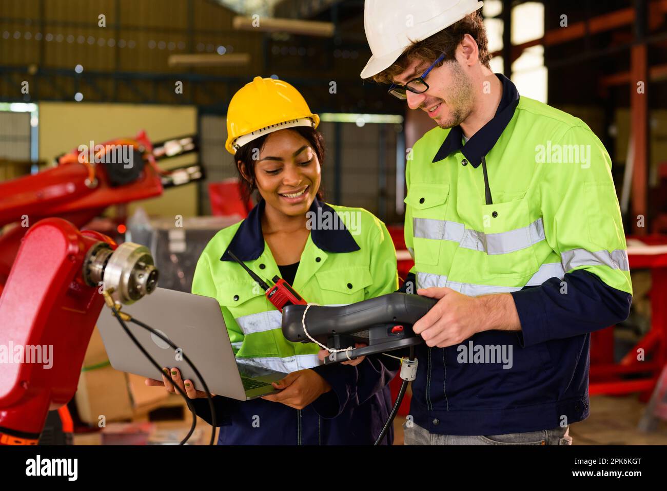 Technician engineer holding robot controller checking and repairing ...