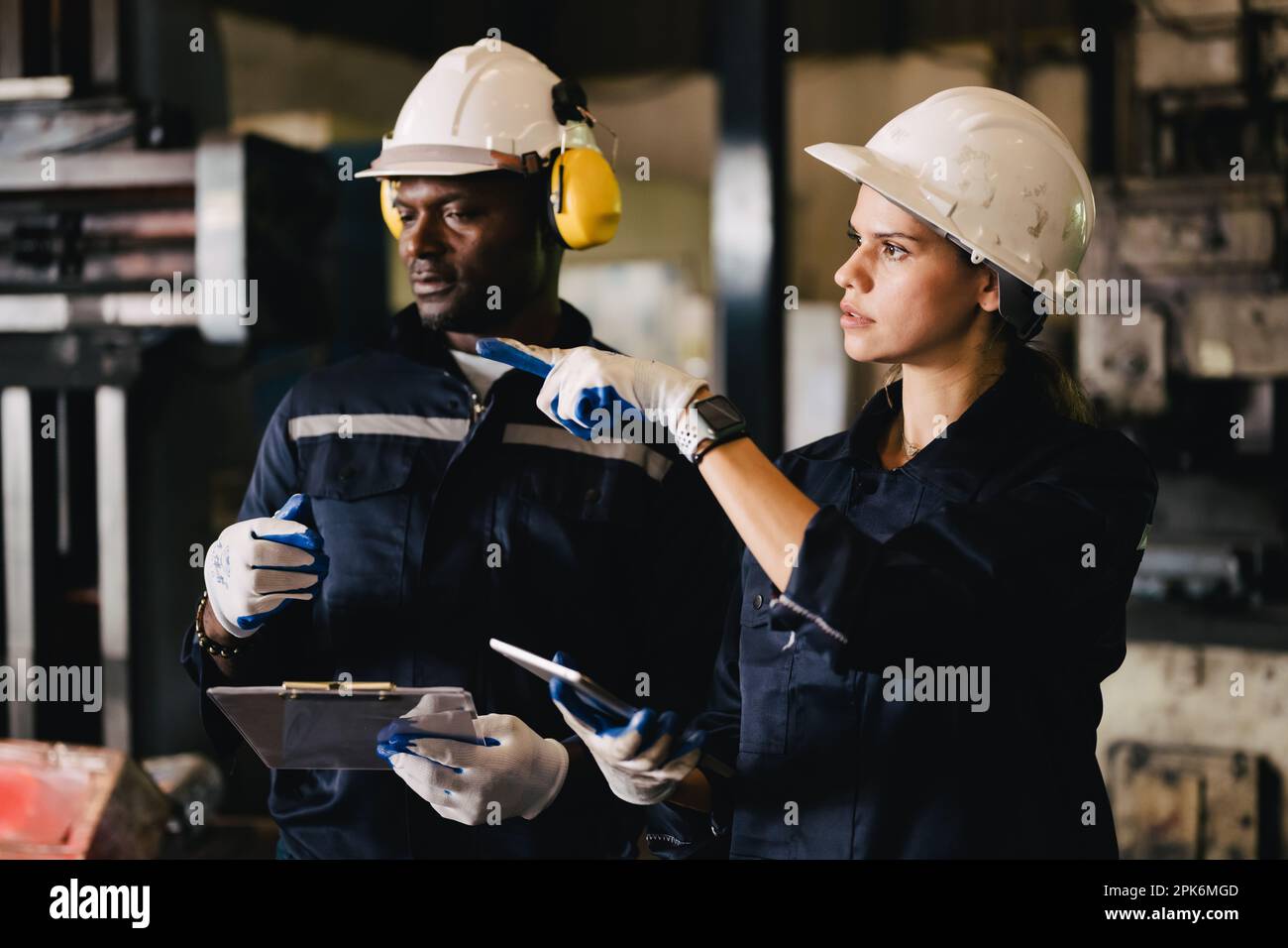 Two technicians engineers workers holding tablet checking Stock Photo ...