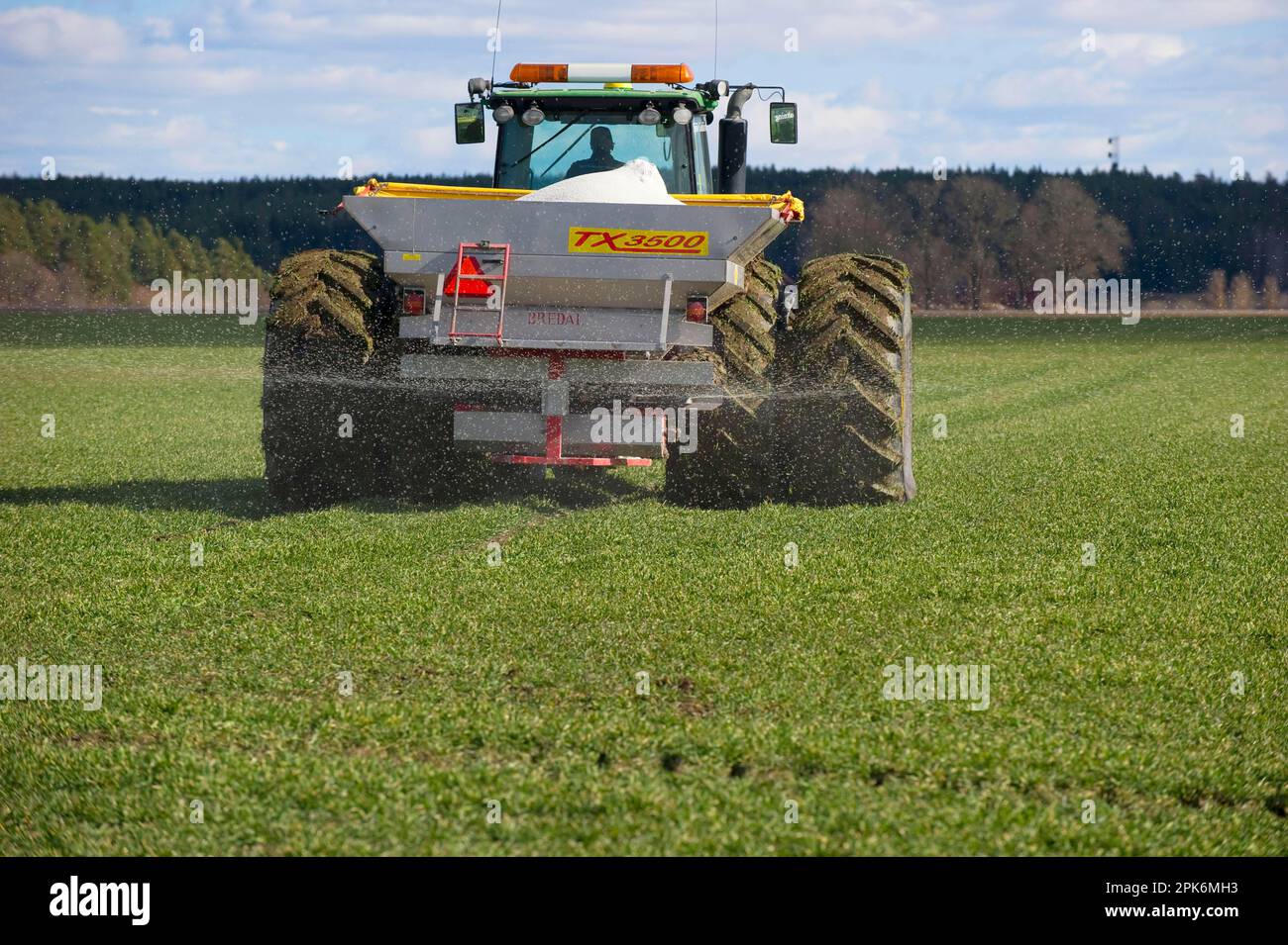 John Deere 8530 tractor with Bredal TX3500 spreader, spreading granular ...