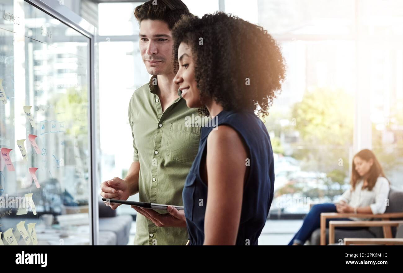 Coming up with big and bold ideas. two businesspeople brainstorming on ...