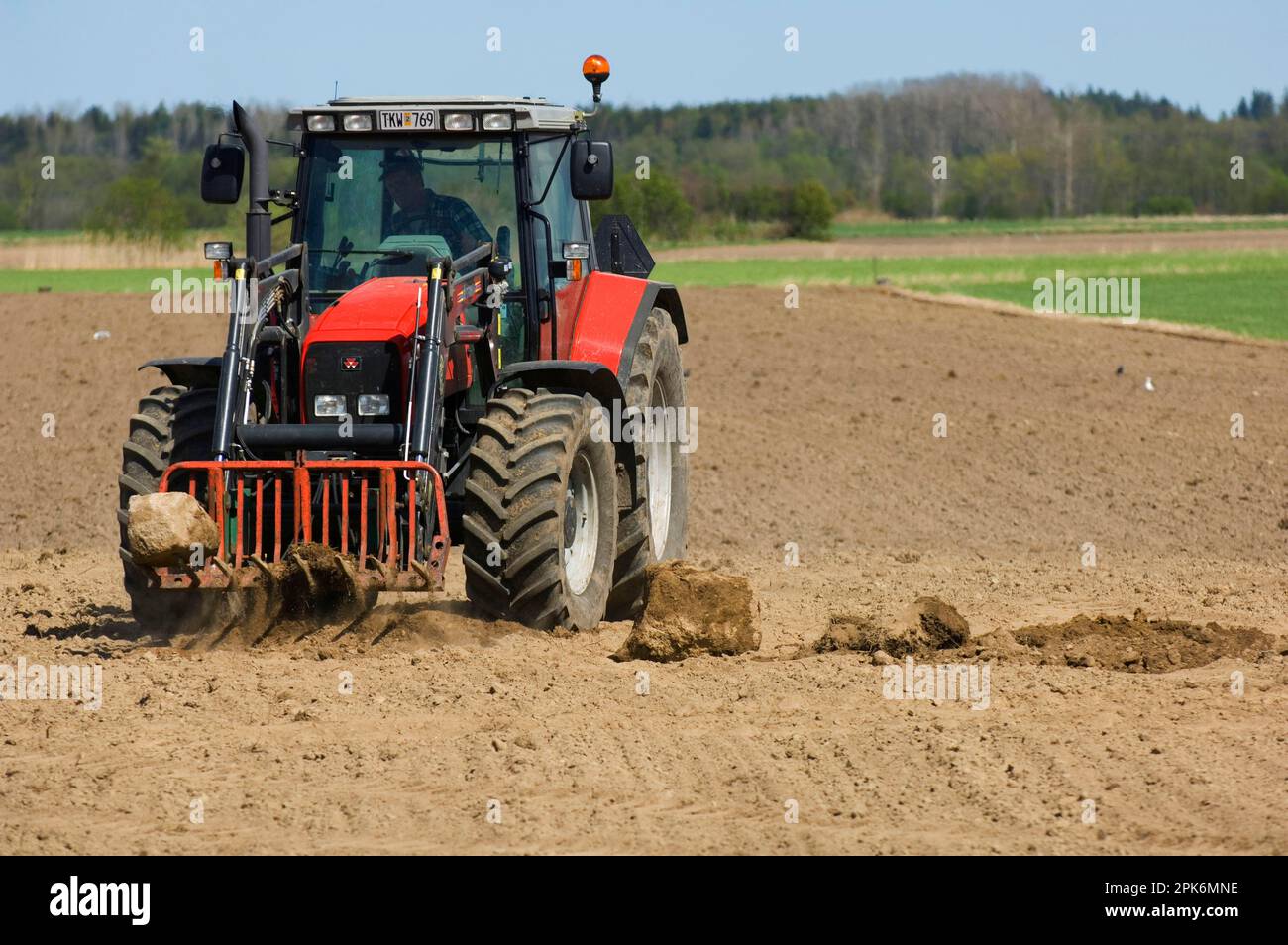 Massey Ferguson 6290 tractor with front loader forks, removes large ...