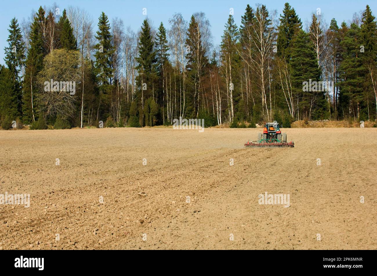 Harrow pulling tractor, harrow field, Sweden, spring Stock Photo - Alamy