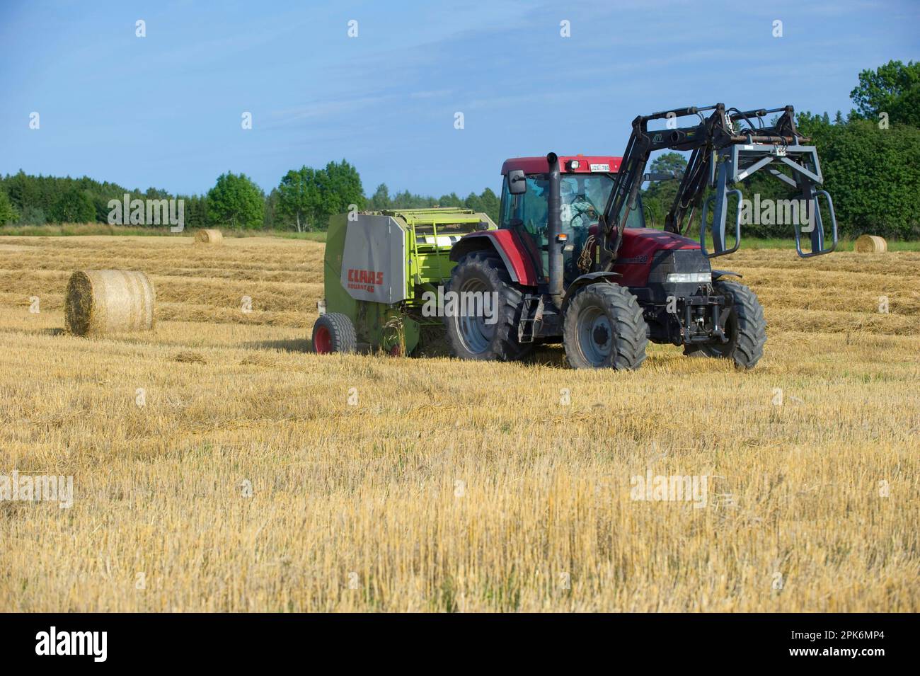 Case MX120 tractor with Trima loader and Claas round baler, baling ...