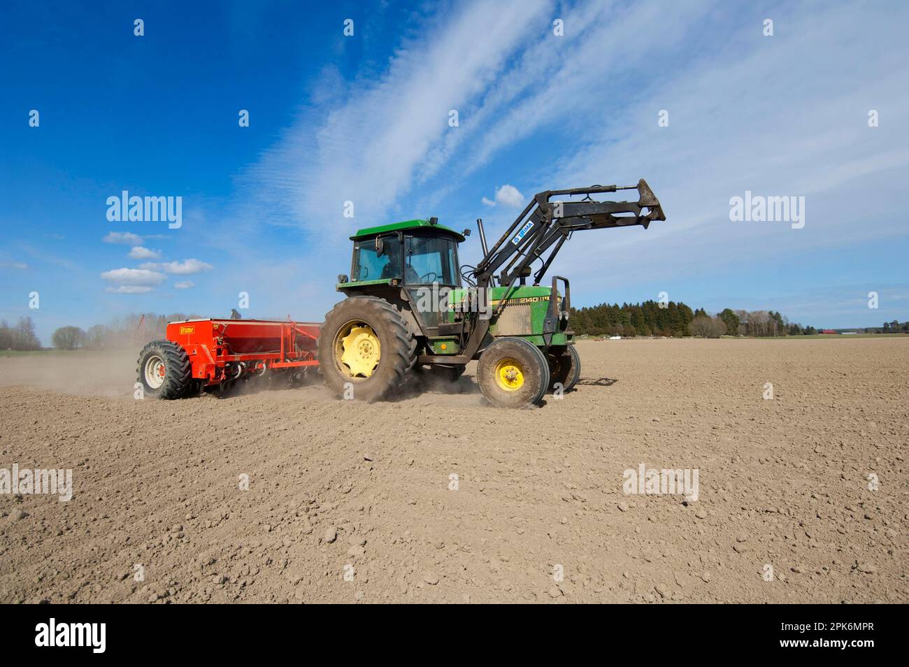 John Deere 2140 tractor with Tume seeder, sowing arable crops in dusty ...