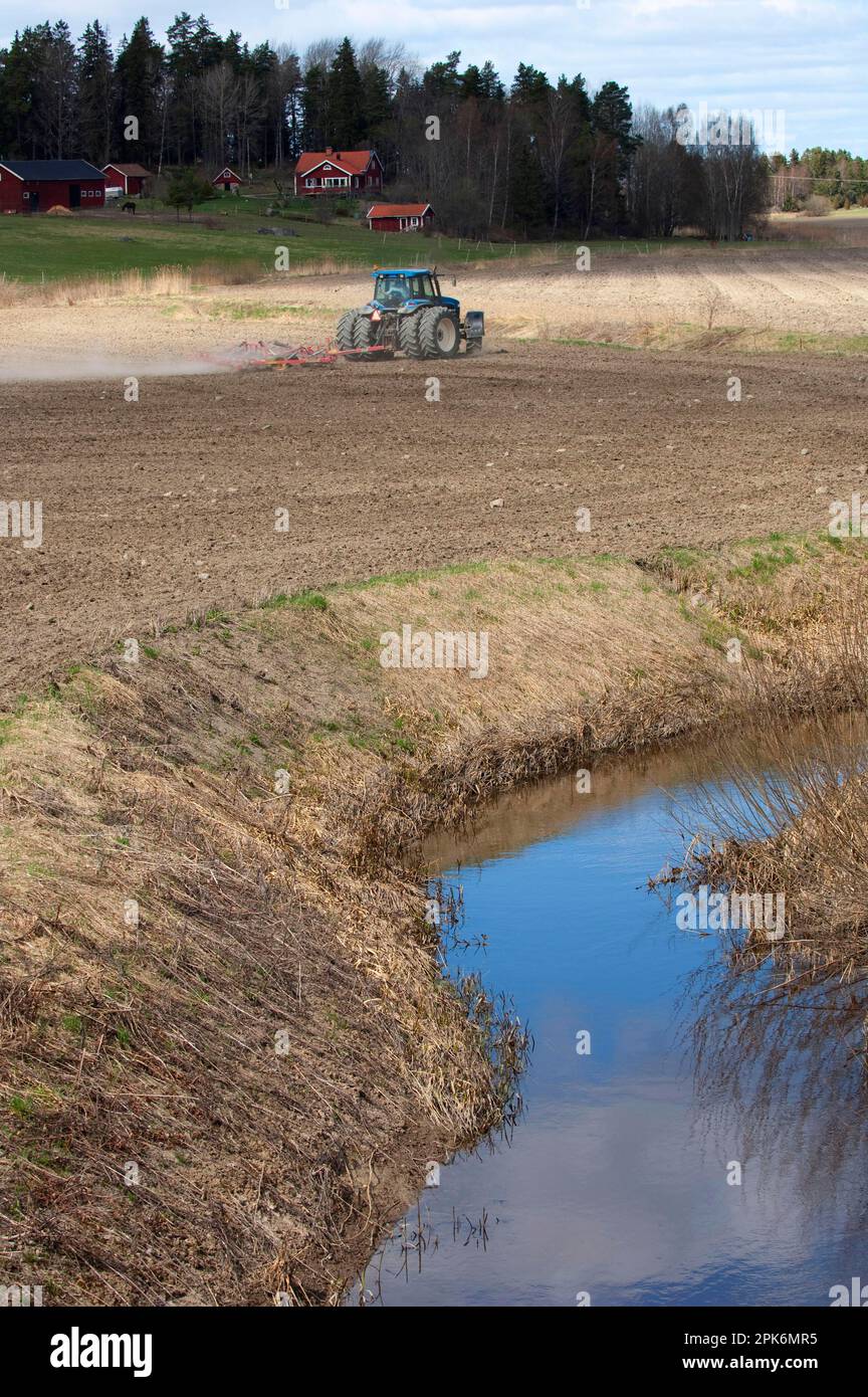 New Holland 8770 tractor with harrows, harrow field seedbed next to ...