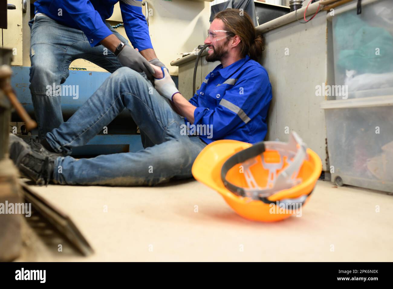 Engineer worker with accident at factory during working Stock Photo - Alamy