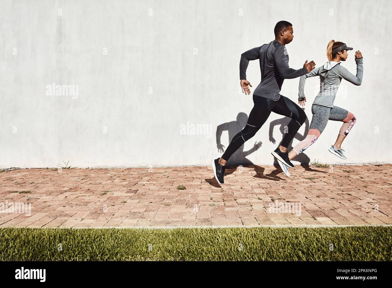 Pushing each other to achieve their fitness goals. Full length shot of ...