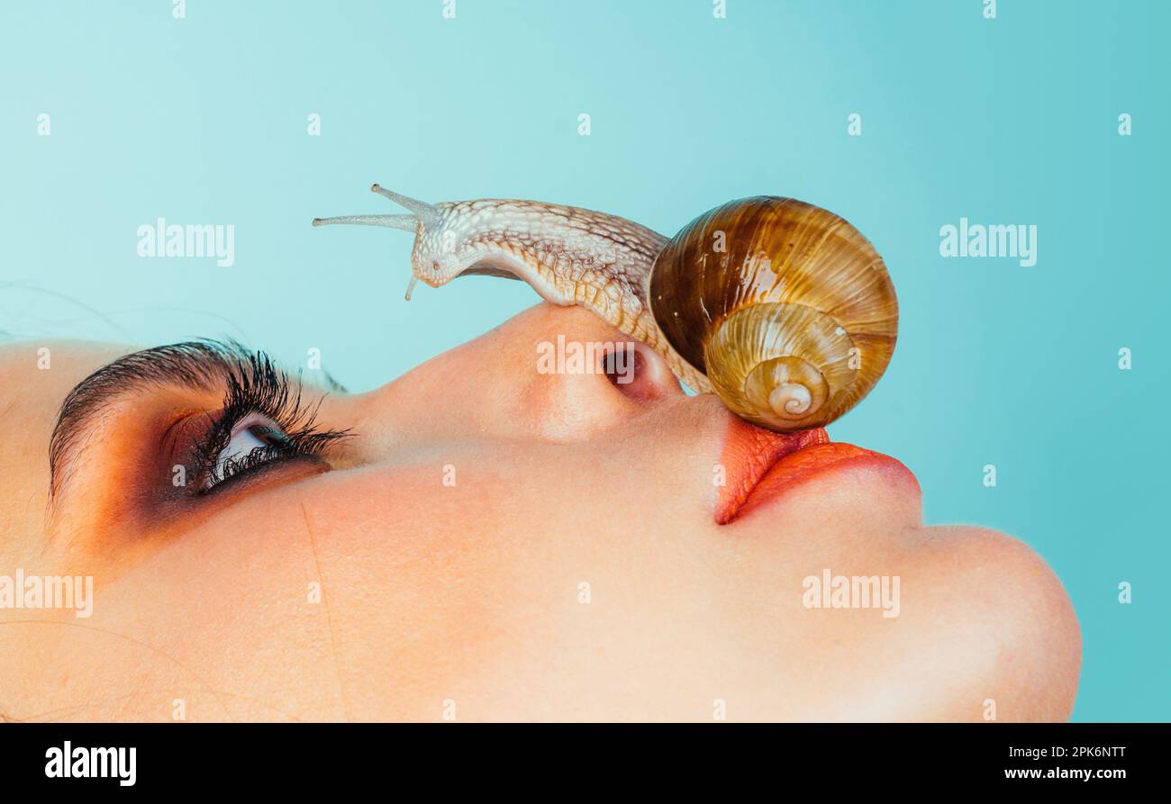 Girl fashionable makeup face and cute snail. Skin care. Massage with ...