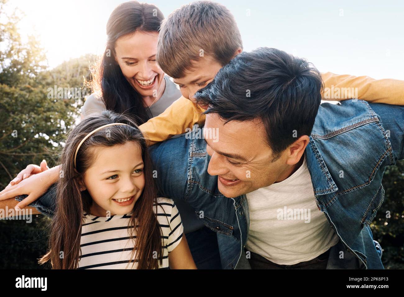 Fun times with family. a happy family of four having fun outdoors Stock ...