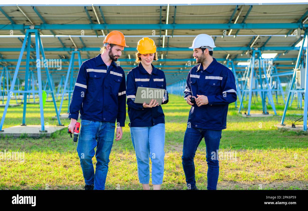 Workers installing solar panels, Engineer team at solar panel farm ...