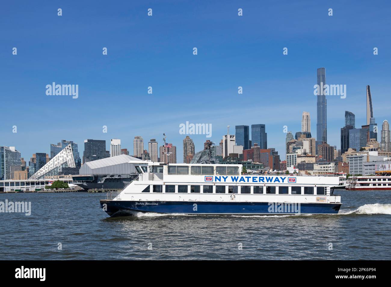 Ferry across the Hudson River in front of the USS Intreprid Sea-Air ...
