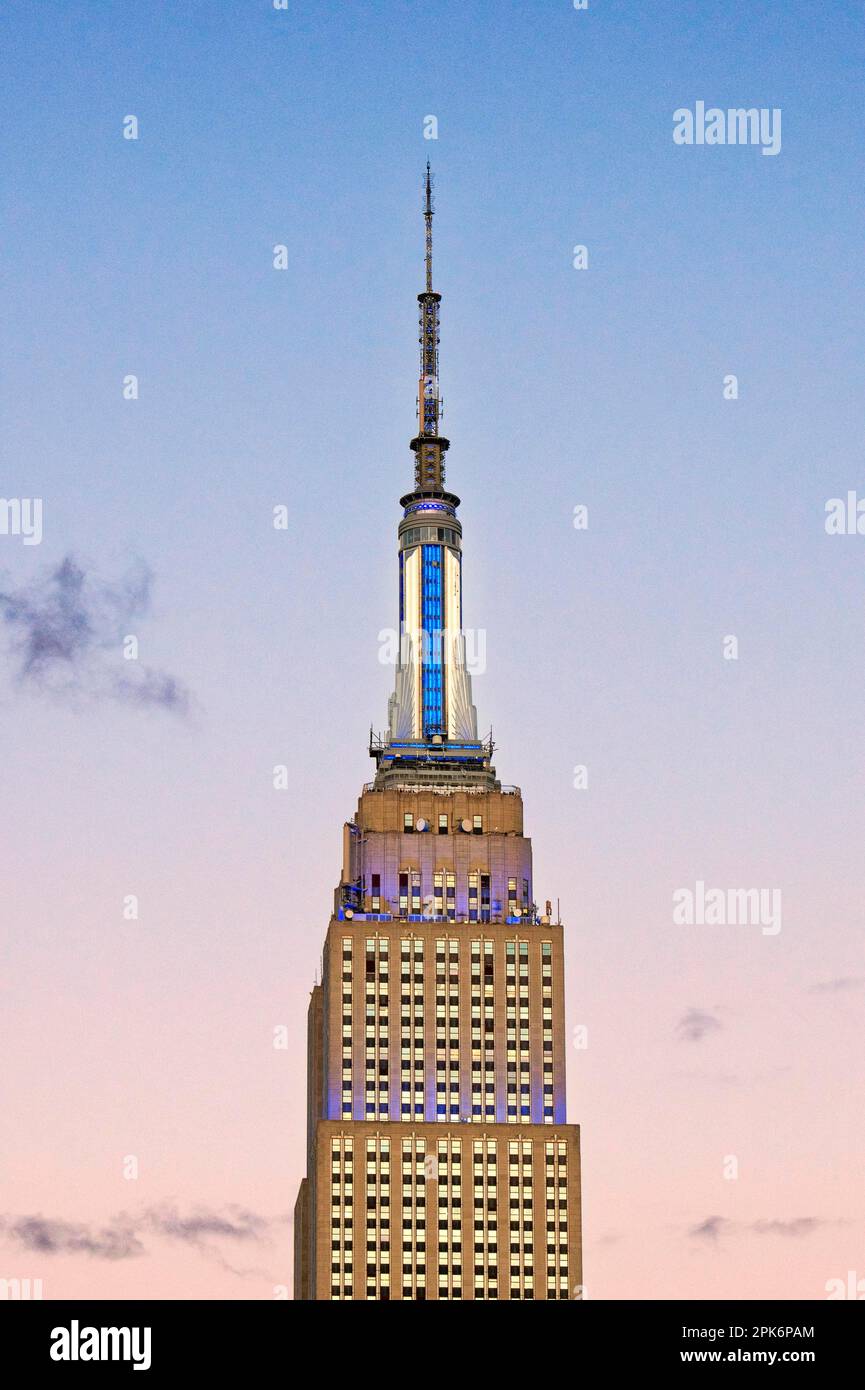 Empire State Building glows white-blue, Manhattan, New York City, USA ...