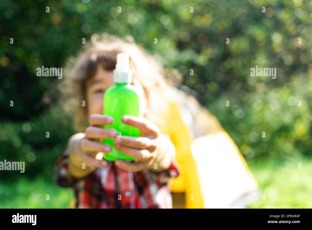 Girl uses a remedy for mosquitoes and biting insects in nature ...