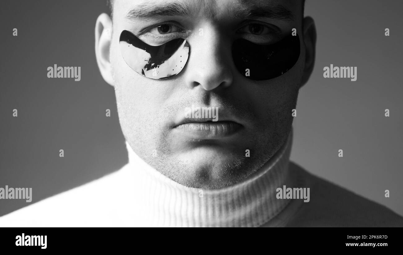 Man with black eye patches close up face. Beauty treatment. Skin care ...