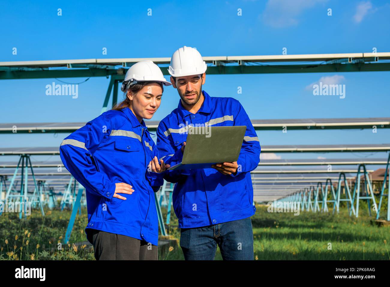 Workers installing solar panels, Engineer team at solar panel farm ...