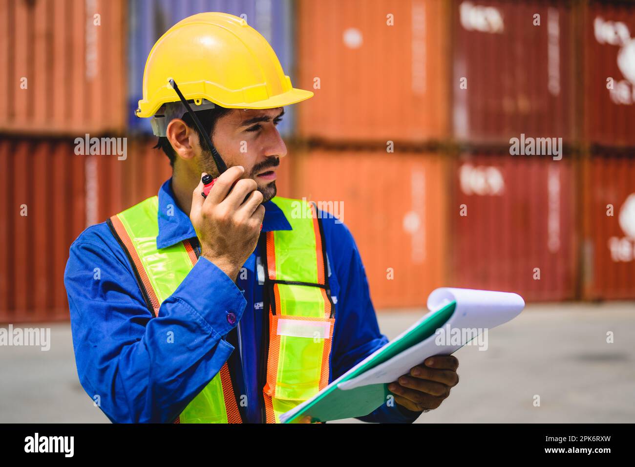 Professional industrial engineer worker working at container cargo yard ...