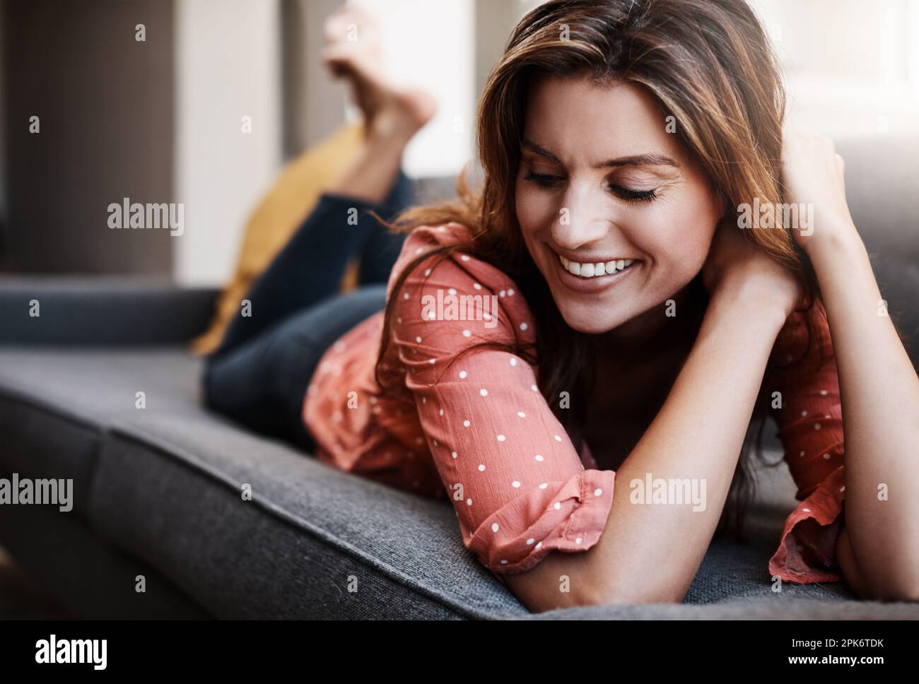 The undeniable magic of me time. an attractive young woman relaxing on ...