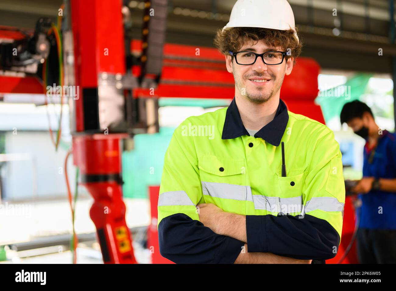 Portrait of happy male mechanical engineer in white hard hat and safety ...
