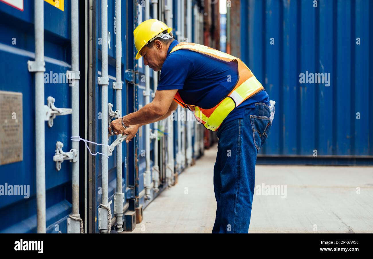 Industrial logistic worker working at overseas shipping container yard ...