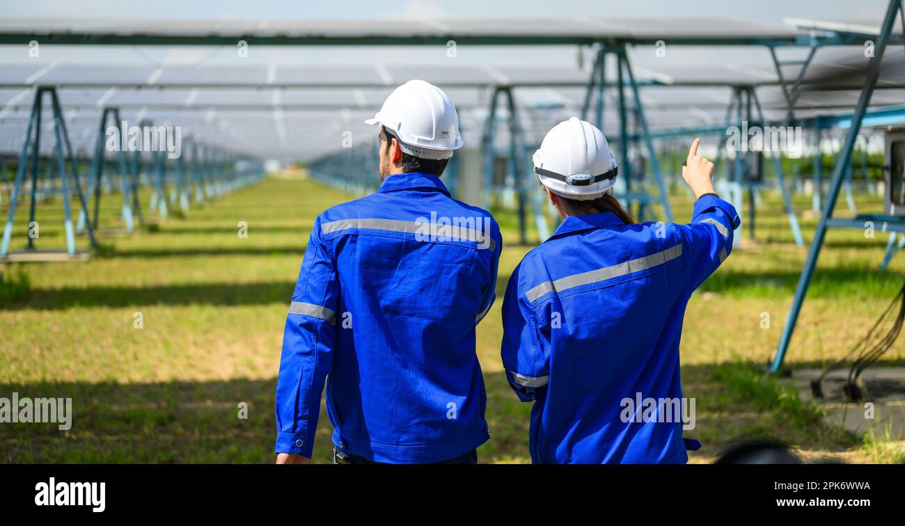 Workers installing solar panels, Engineer team at solar panel farm ...