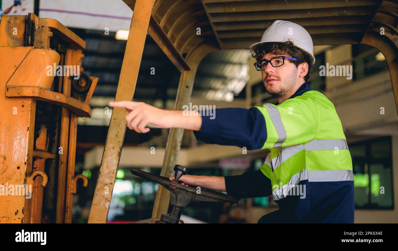 Portrait of happy male mechanical engineer in white hard hat and safety ...