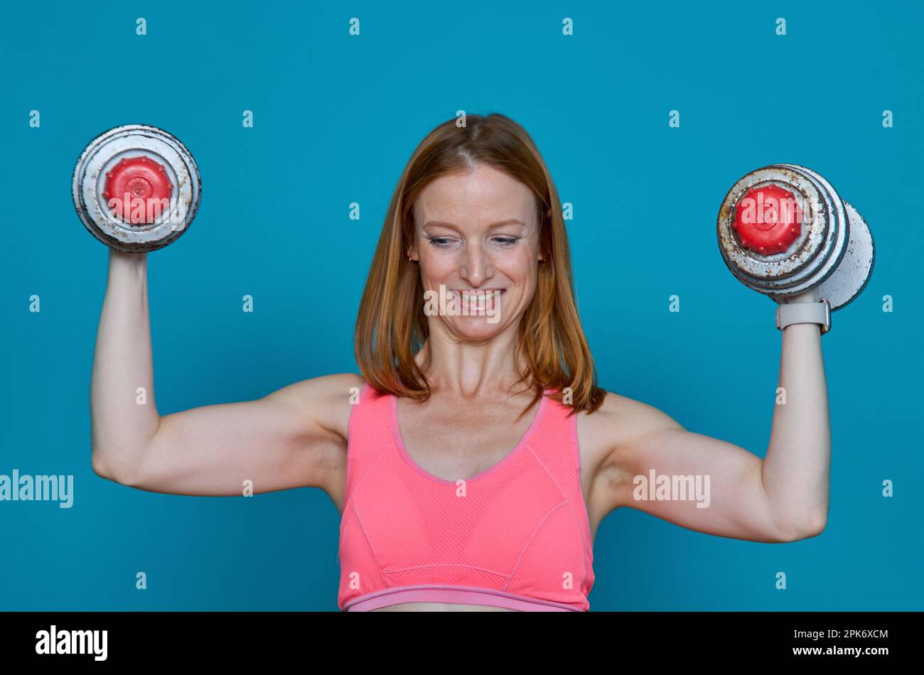 Woman doing triceps exercise dumbbells hi-res stock photography and ...