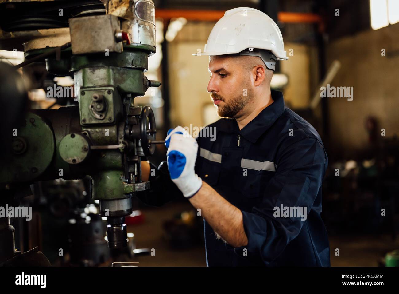 Professional male technician checking and repairing machinery Stock ...