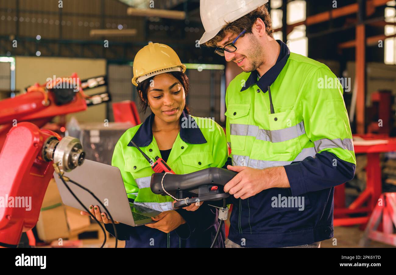 Happy male and female mechanical engineers in hard hat and safety ...