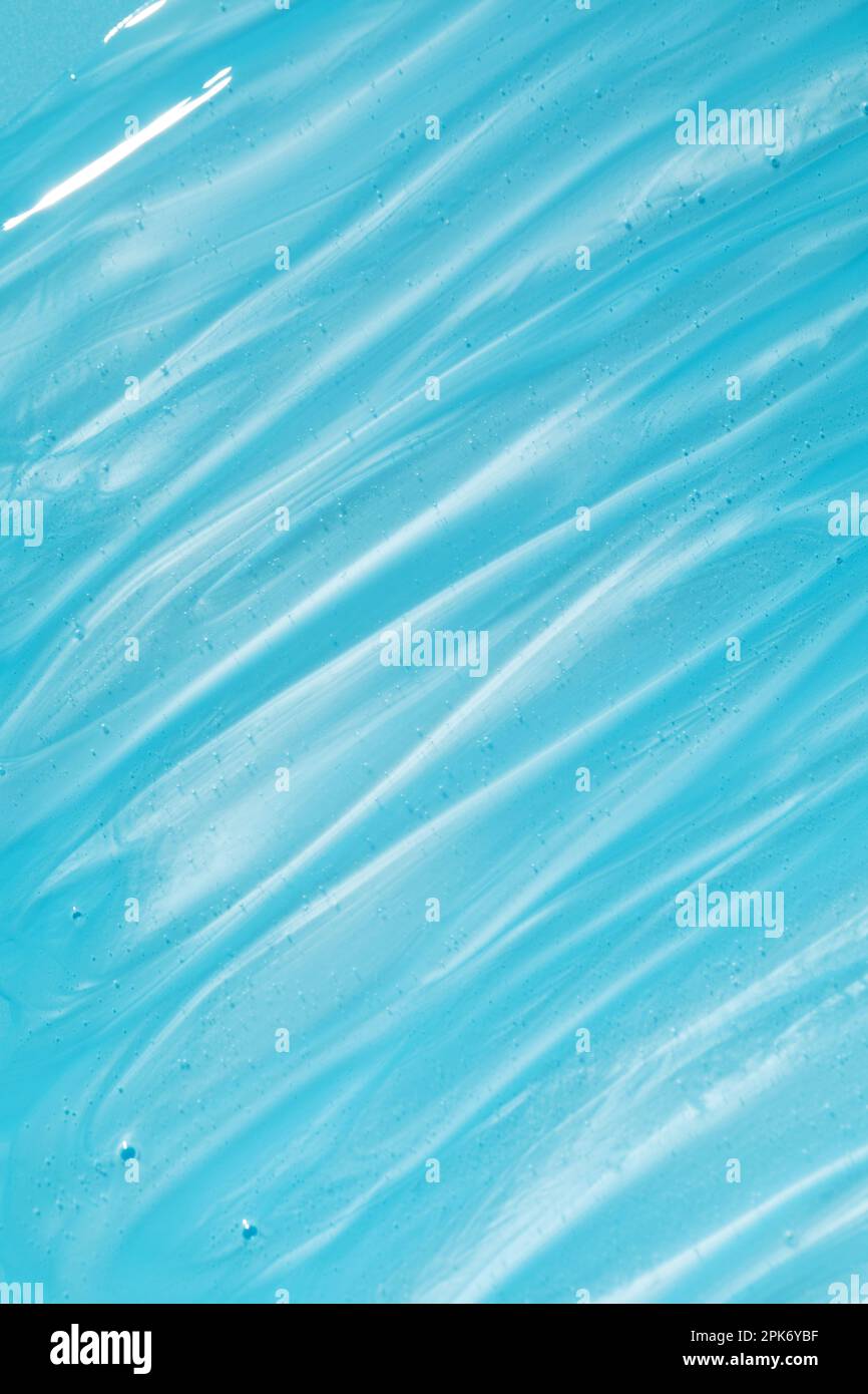 The texture of a transparent gel on a blue background. Swatch. A sample ...