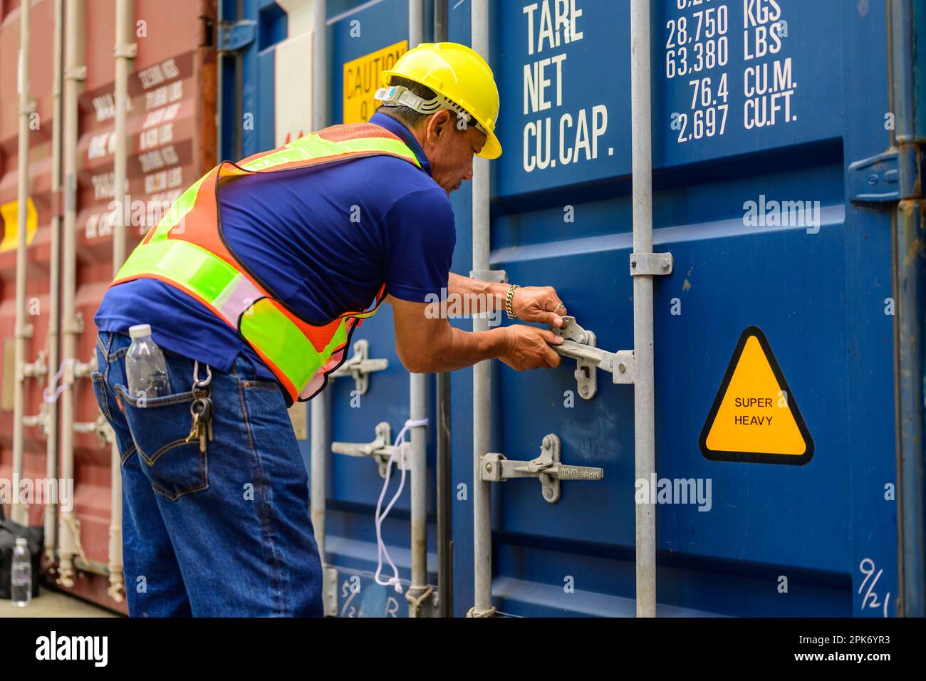 Logistics worker opening and closing door of container box at container yard Stock Photo - Alamy