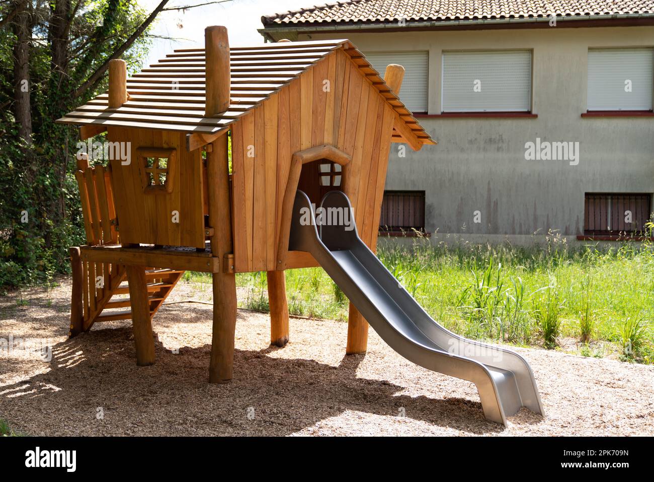playground in urban park forest with wooden hut and slide Stock Photo ...