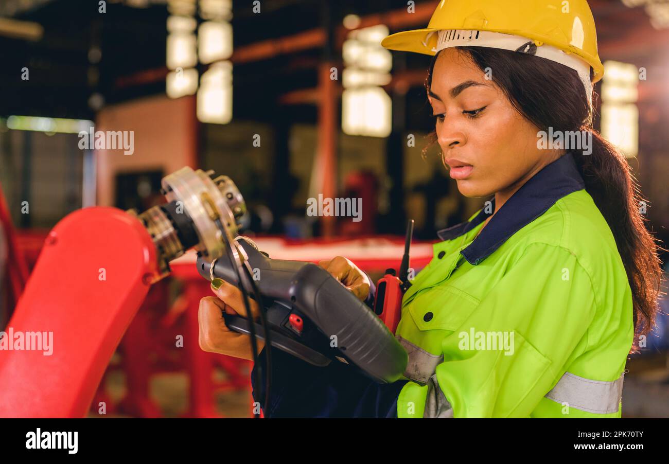 Technician engineer checking and repairing automatic robotic machine ...