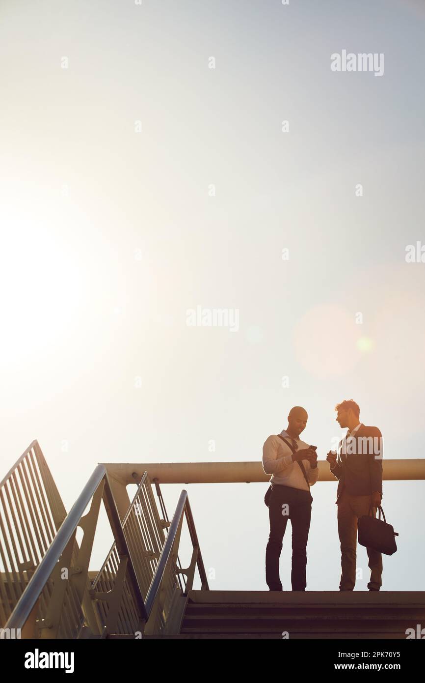 Networking is important in business. Low angle shot of two businessmen ...