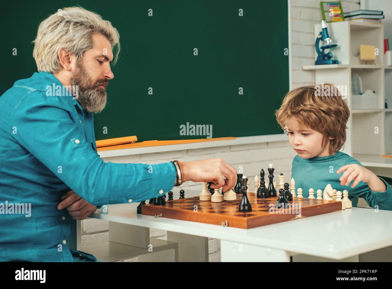 Father with son playing Chess at home. Happy two generations of men ...