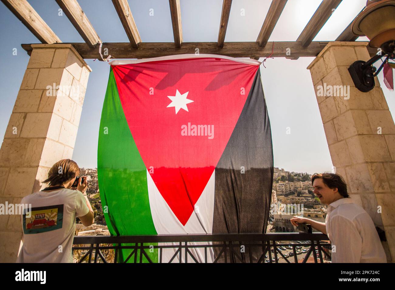 Flag of Jordan over Amman Stock Photo - Alamy
