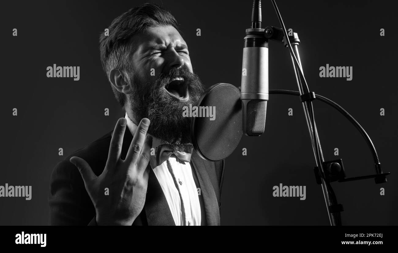 Singer is performing a song with a microphone while recording in a ...