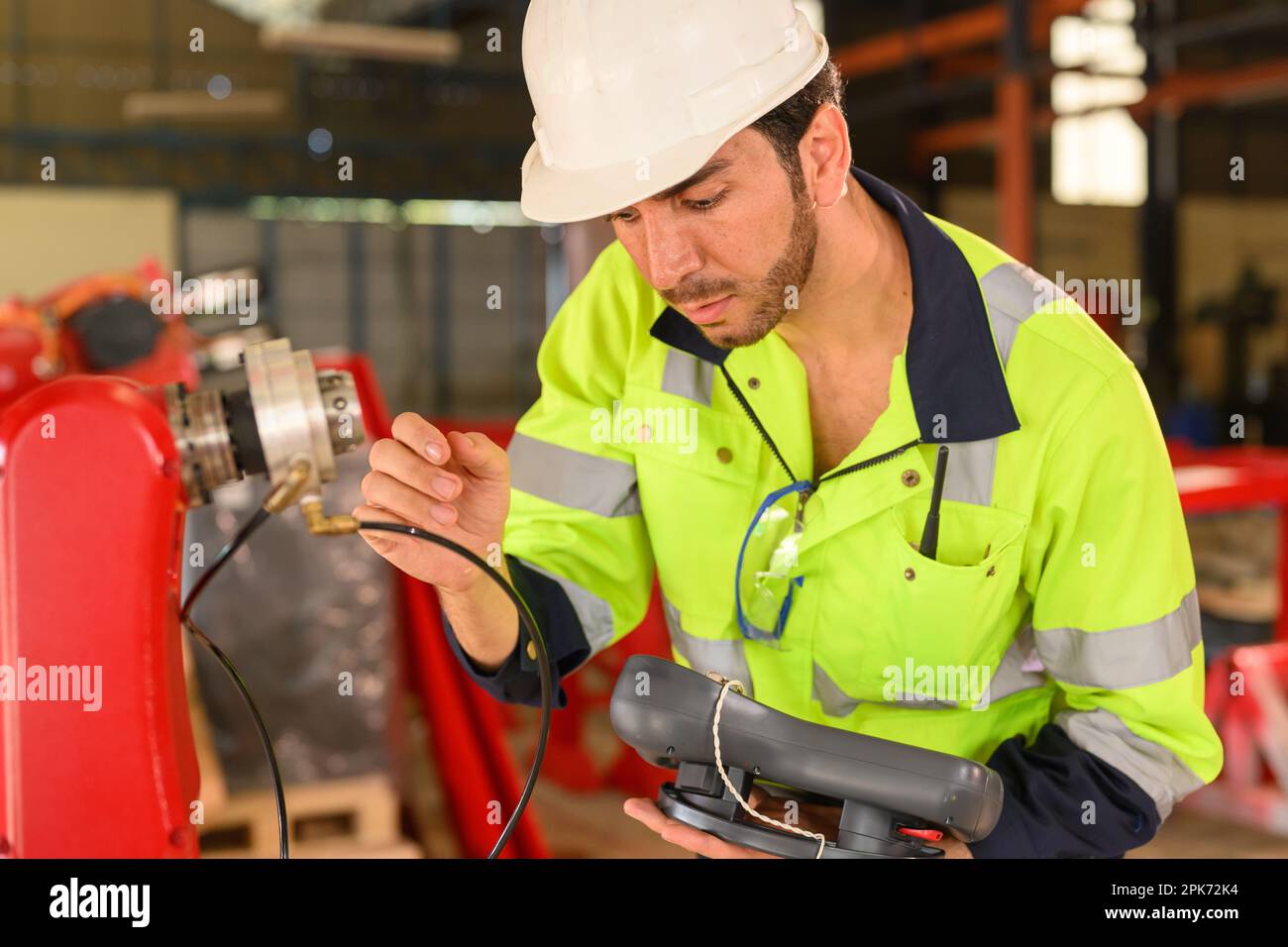 Professional male industrial worker in white hard hat and protective ...