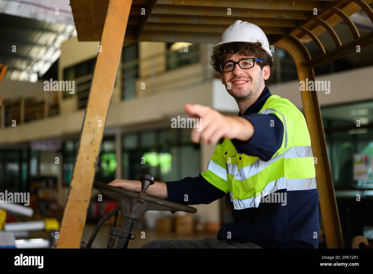 Portrait of happy male mechanical engineer in white hard hat and safety ...