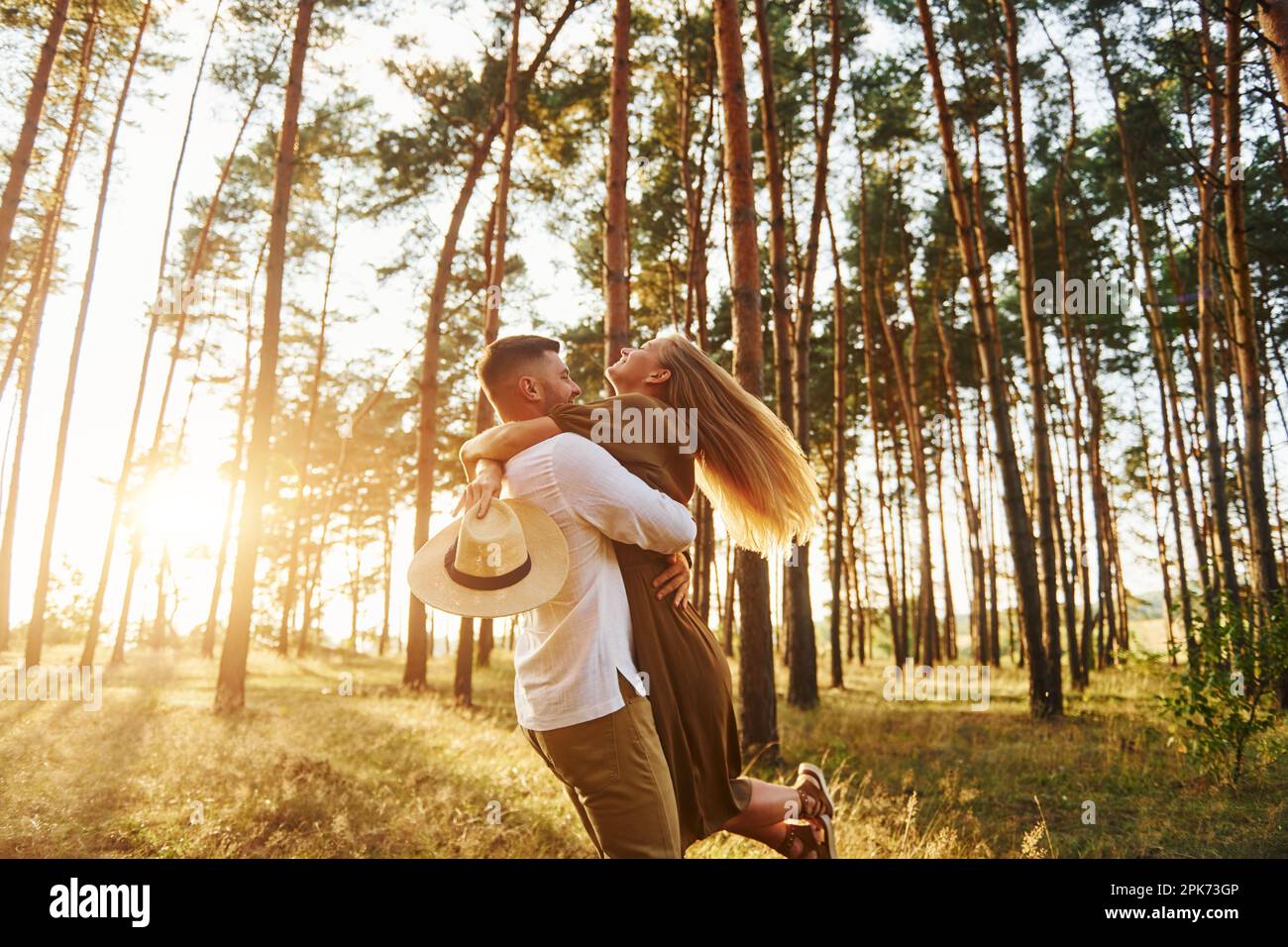 Against background with sunshine. Happy couple is outdoors in the ...