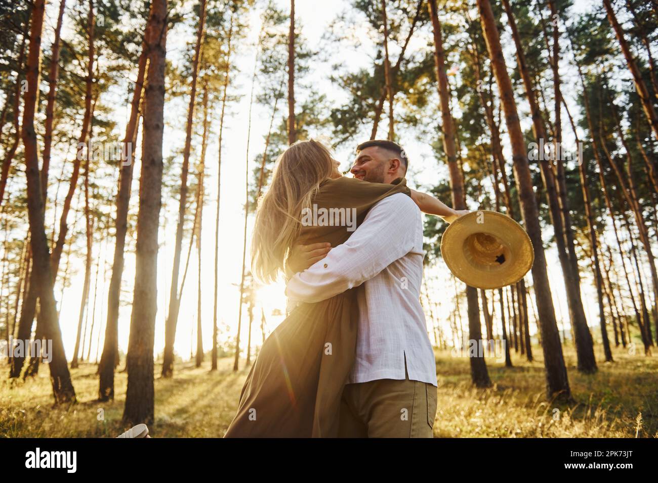 Embracing and kissing. Happy couple is outdoors in the forest at ...