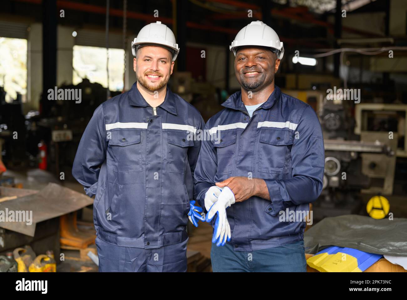 Two industrial engineers team with safety uniform Stock Photo - Alamy